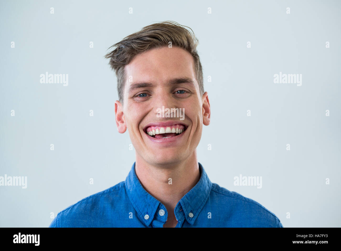 Smiling man blue shirt hi-res stock photography and images - Alamy