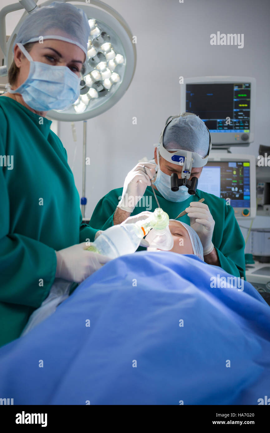 Surgeons operating patient Stock Photo - Alamy