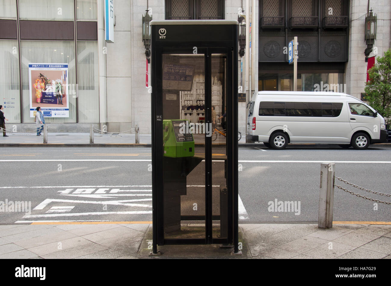 Public telephone on pathway beside traffic road for people use phone at ...