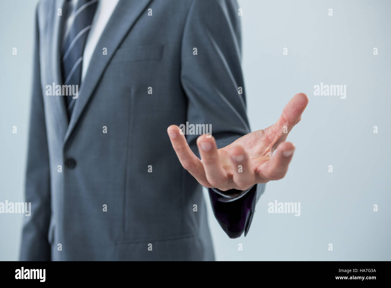 Mid section of businessman making hand gesture Stock Photo - Alamy