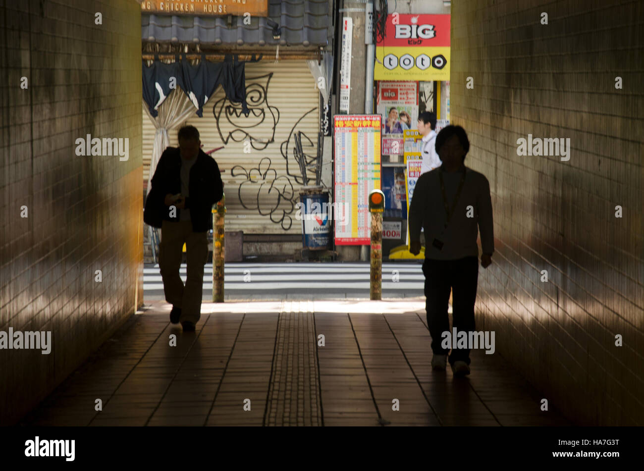 Japanese and foreigner people walking in tunnel under road or underpass ...