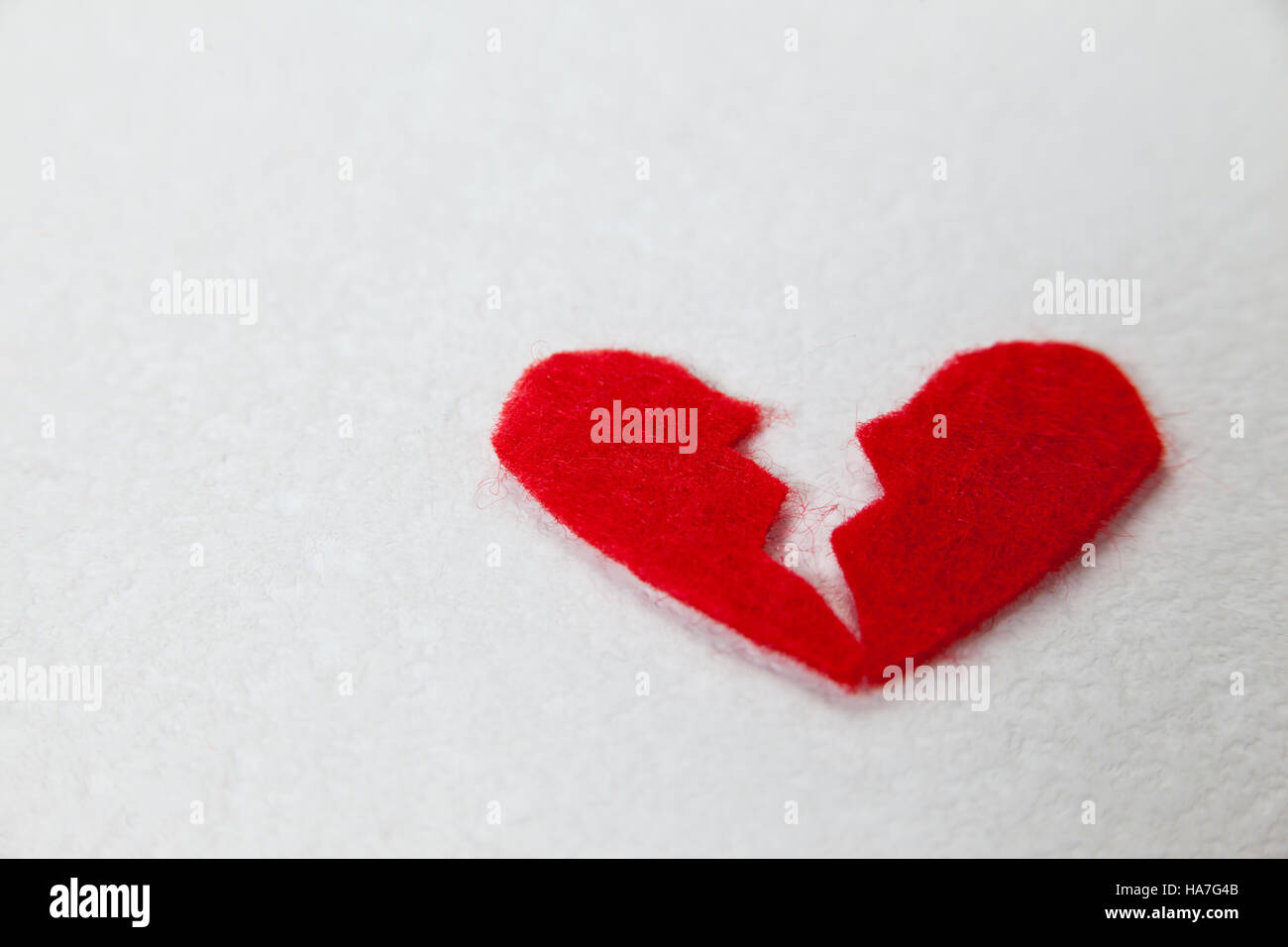 Red broken heart on white background Stock Photo - Alamy