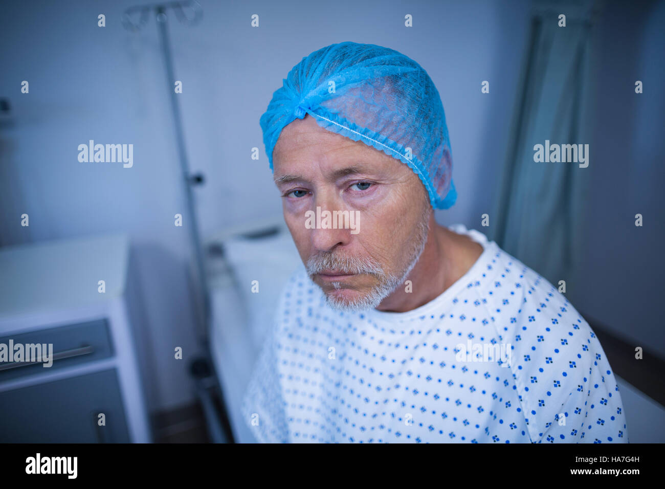 Portrait of sick patient sitting on bed Stock Photo - Alamy