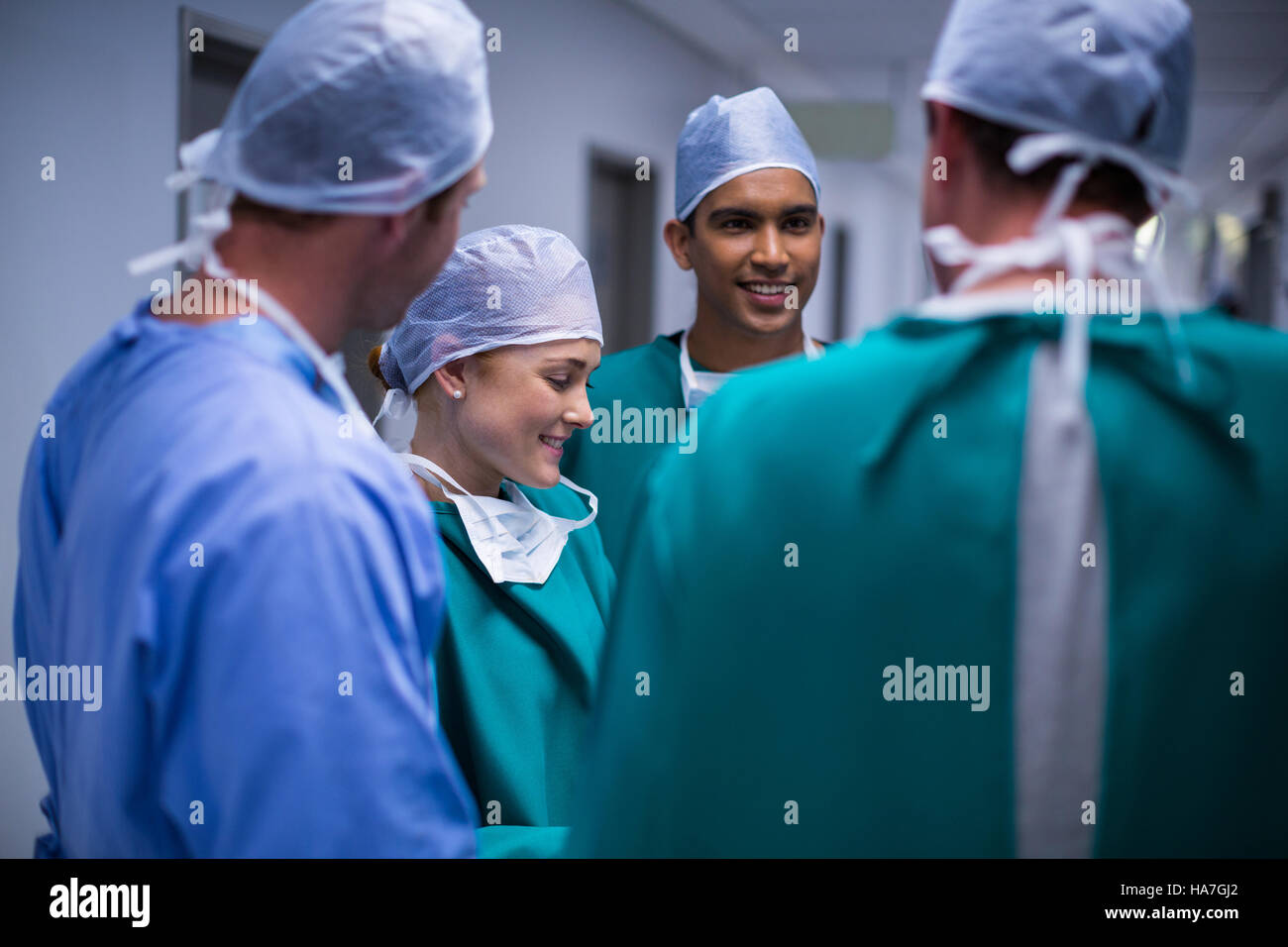 Surgeons having discussion in corridor Stock Photo - Alamy