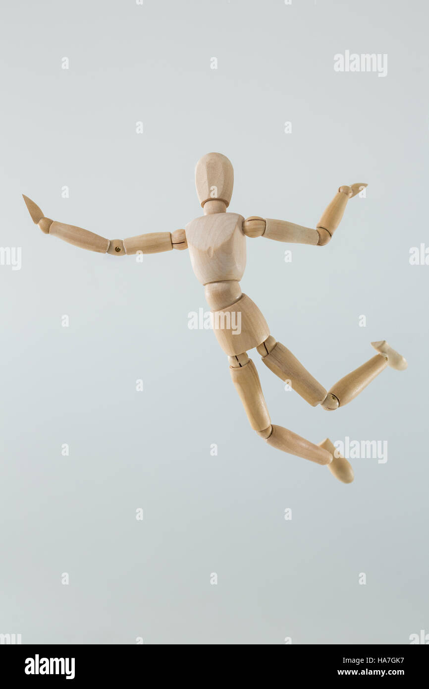 Wooden figurine jumping in the air Stock Photo - Alamy