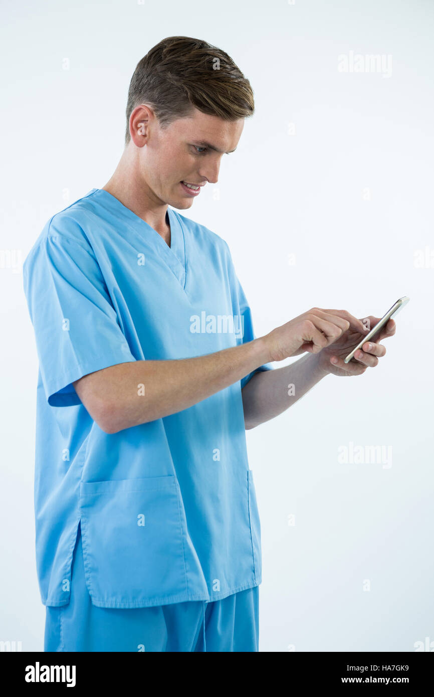 Smiling male nurse using mobile phone Stock Photo - Alamy