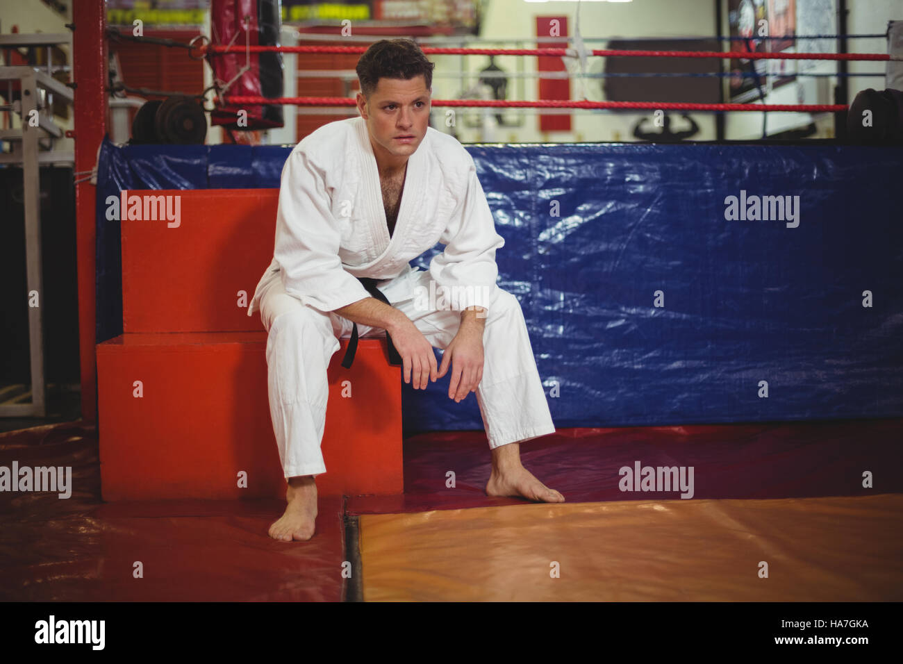 Karate player sitting in fitness studio Stock Photo - Alamy