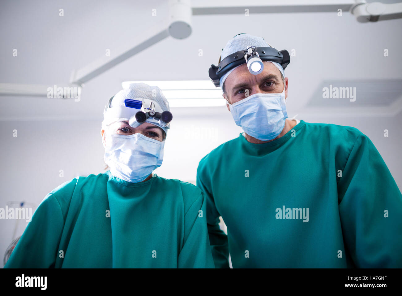Portrait of surgeons with surgical loupes in operation room Stock Photo ...