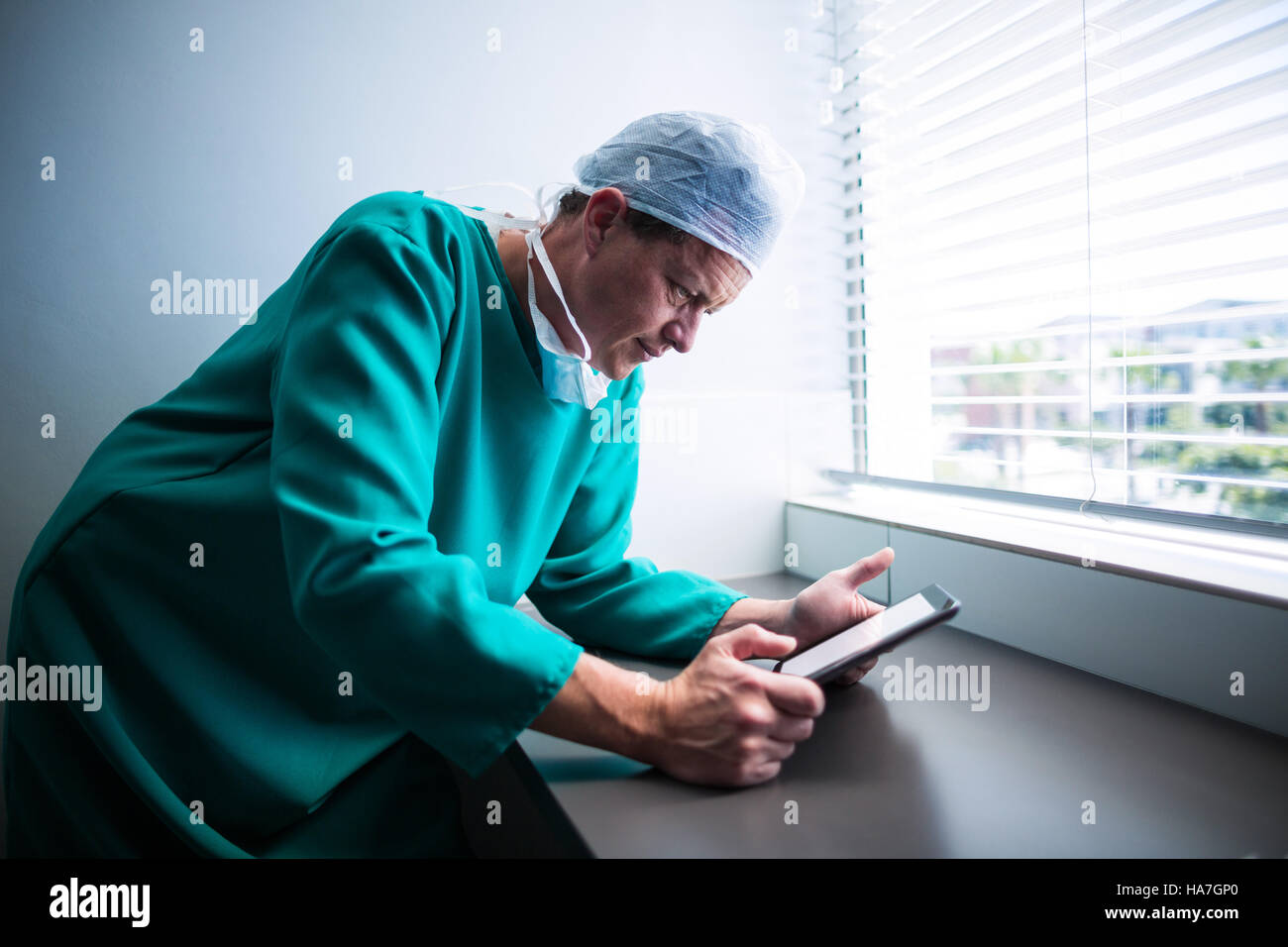 Male surgeon using digital tablet Stock Photo - Alamy