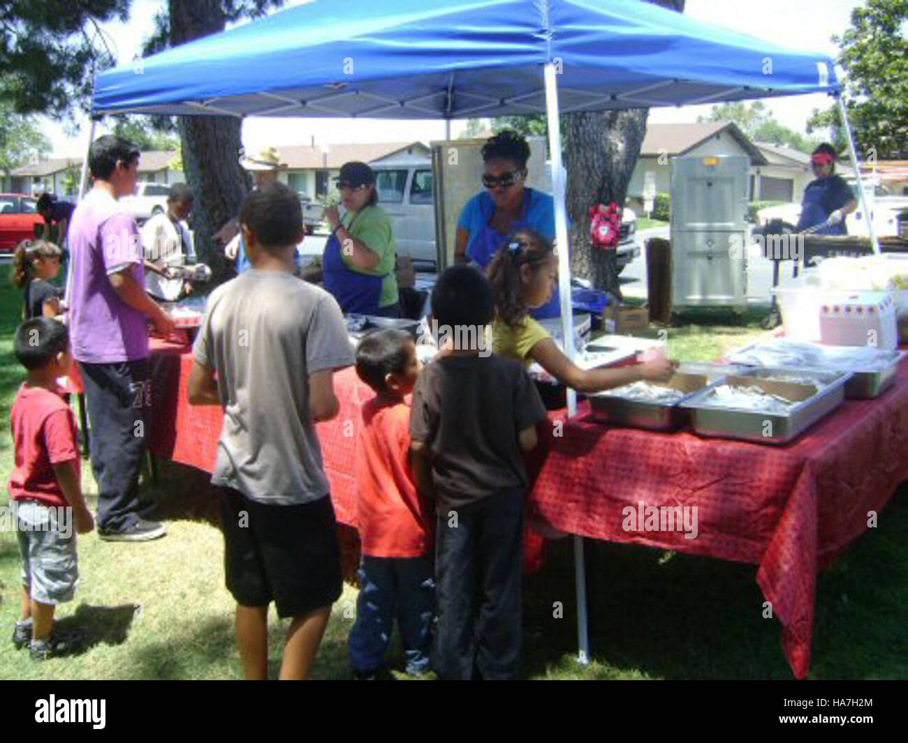 Children and families enjoy a free summer BBQ at Riverside, celebrating ...