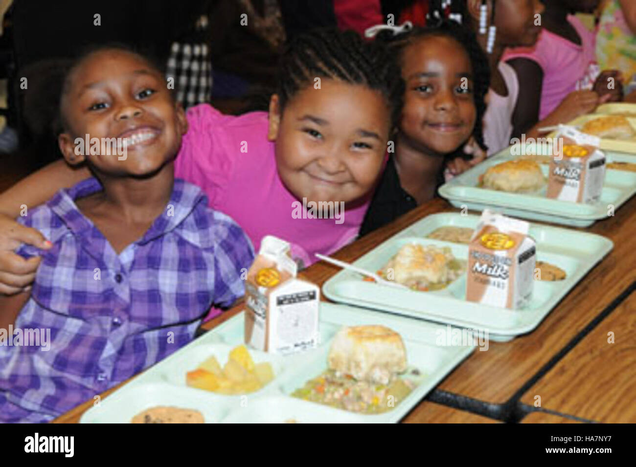 A group of girls smiles during an outdoor activity, engaging in nature ...