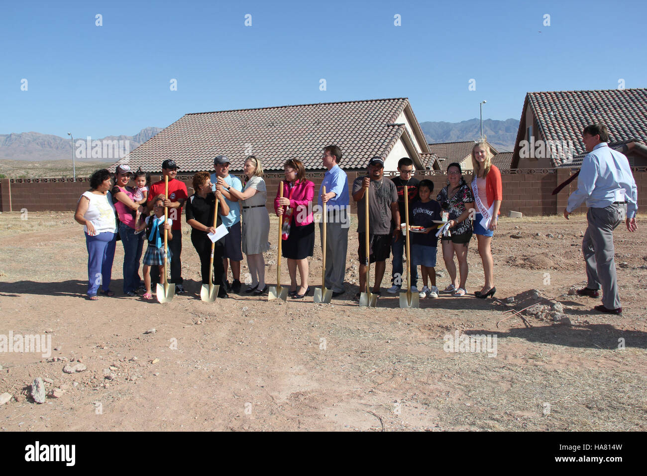 A USDA official uses a shovel as part of land restoration efforts ...