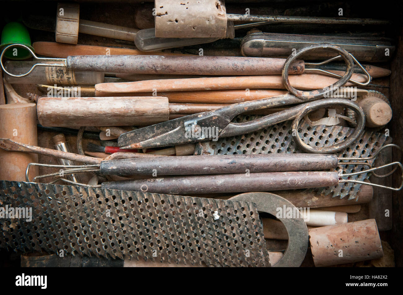 Vintage style tools in a retro tin tool box on a the workshop table ...