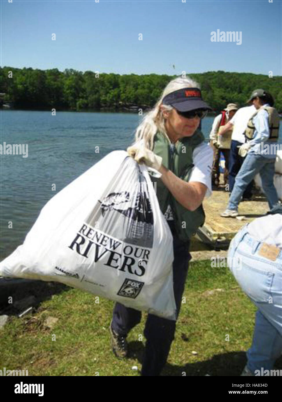 An image illustrating trash accumulation along the banks of a river ...