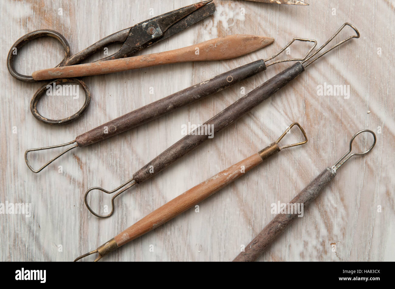Pottery making tools on a white desk Stock Photo - Alamy