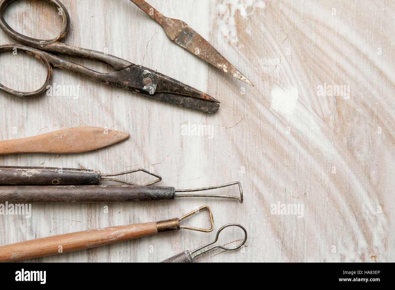 Pottery making tools on a white desk Stock Photo - Alamy