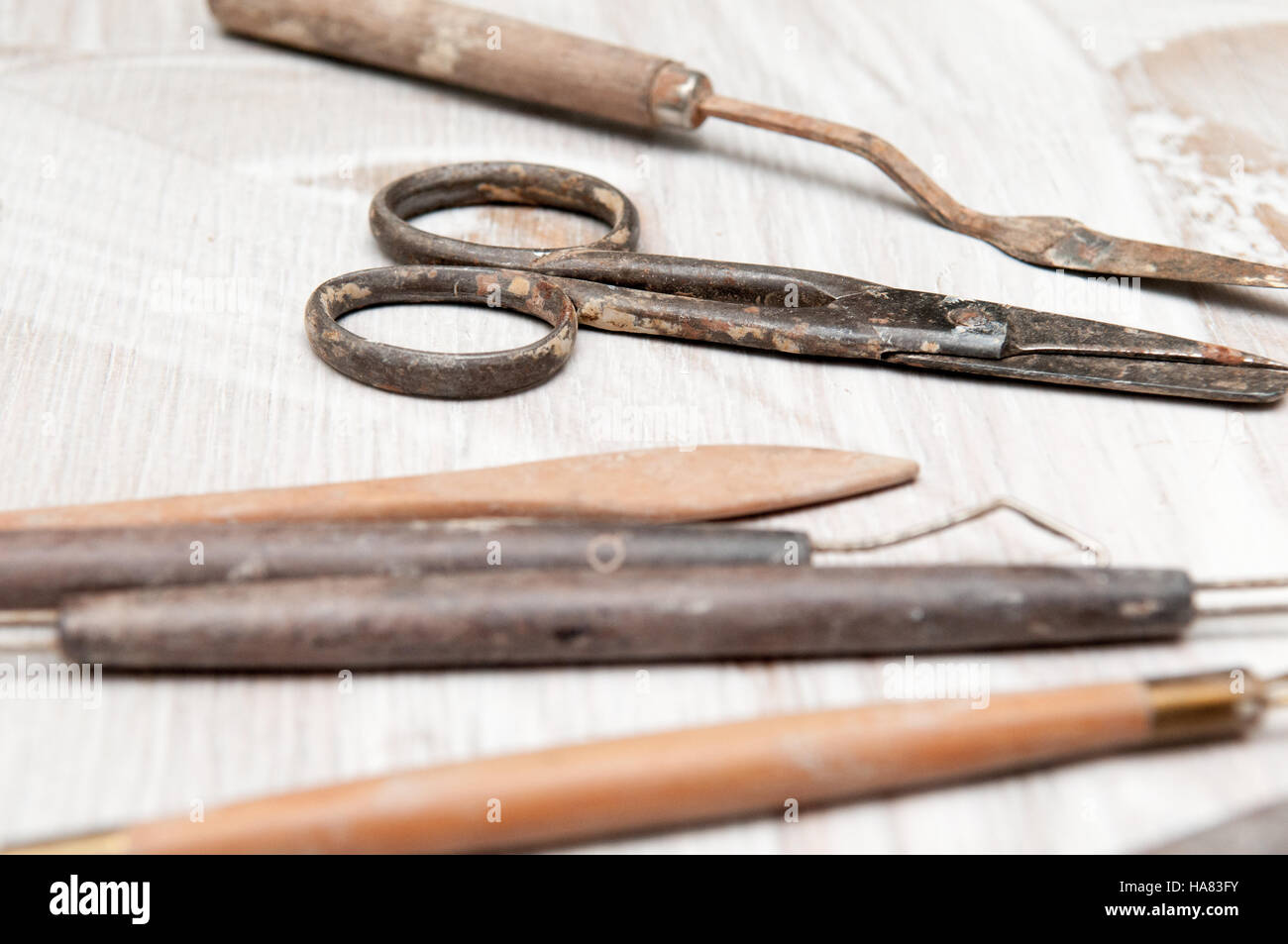 Pottery making tools on a white desk Stock Photo - Alamy
