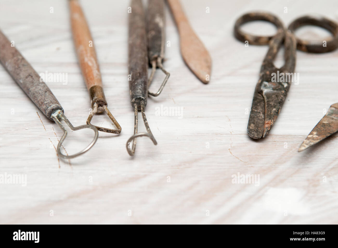 Pottery making tools on a white desk Stock Photo - Alamy