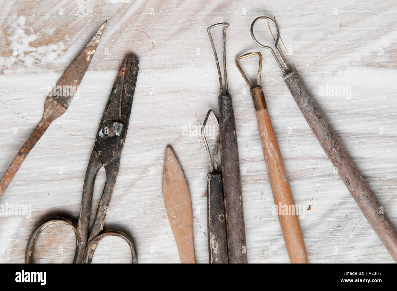Pottery making tools on a white desk Stock Photo - Alamy