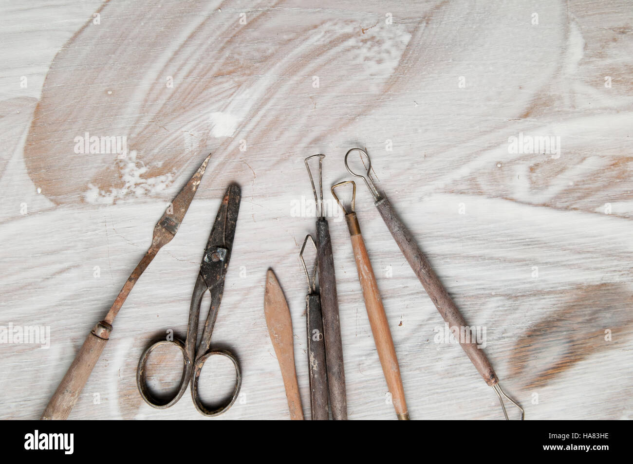 Pottery making tools on a white desk Stock Photo - Alamy