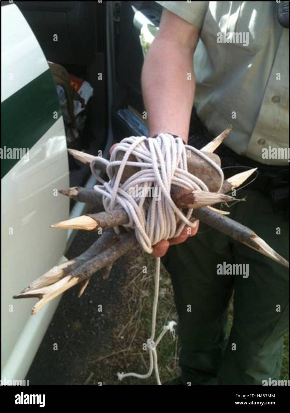 A USDA officer holds a historical example of a booby trap, illustrating ...