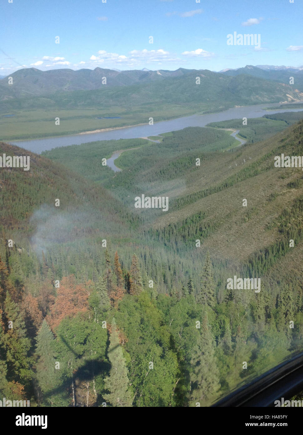 A helicopter view of a wildfire smoke plume in Alaska, captured by ...