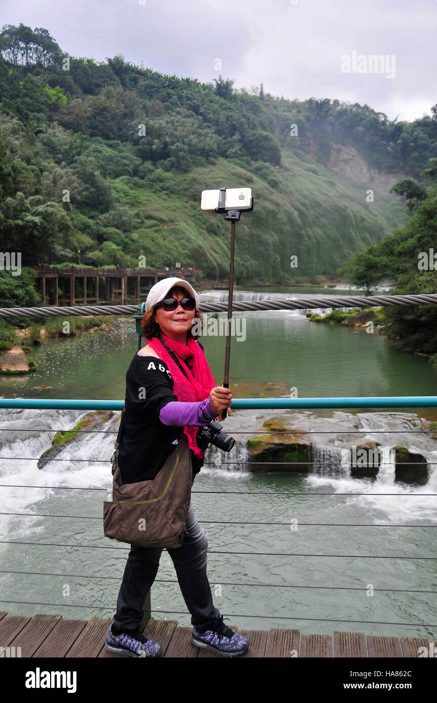 The beautiful Yellow Fruit Tree waterfall (Huangguoshu Waterfall) makes ...