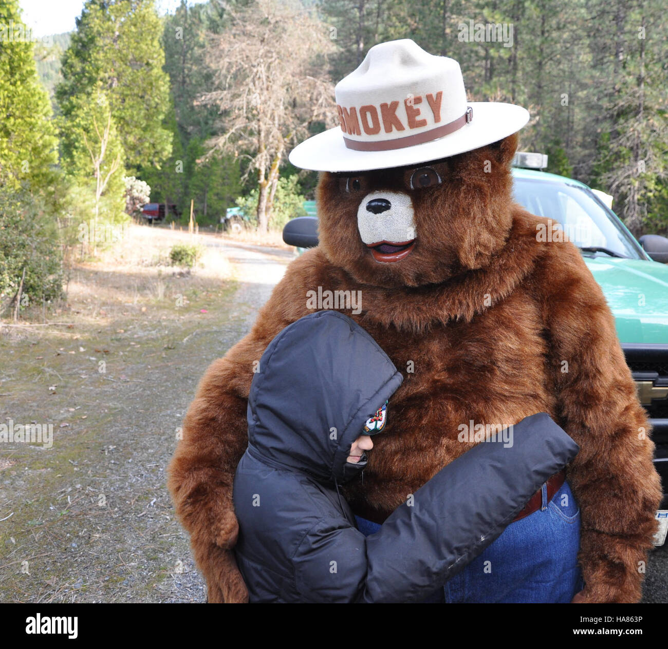 The image depicts Smokey the Bear, a symbol of wildfire prevention ...