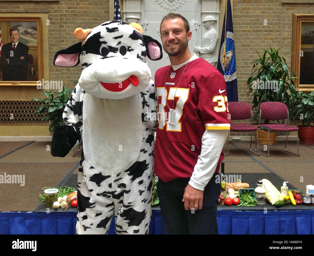 This image shows a USDA official, Doughty, working with a dairy cow ...