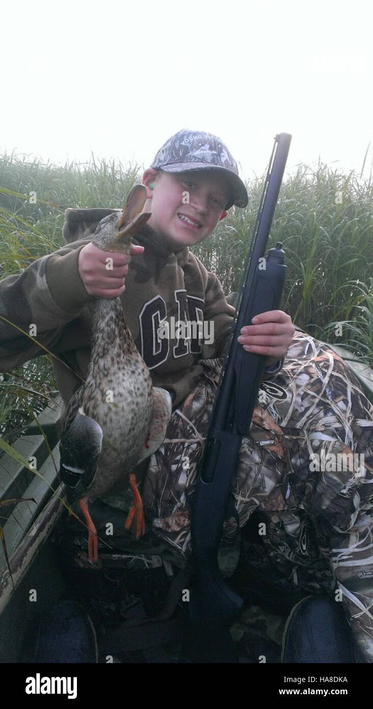 A young waterfowler proudly displays their first duck, marking a ...
