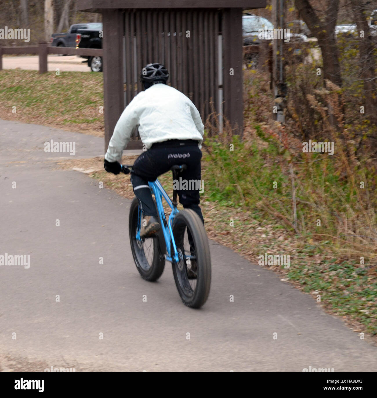 A mountain biker rides along a trail in a national park, showcasing ...