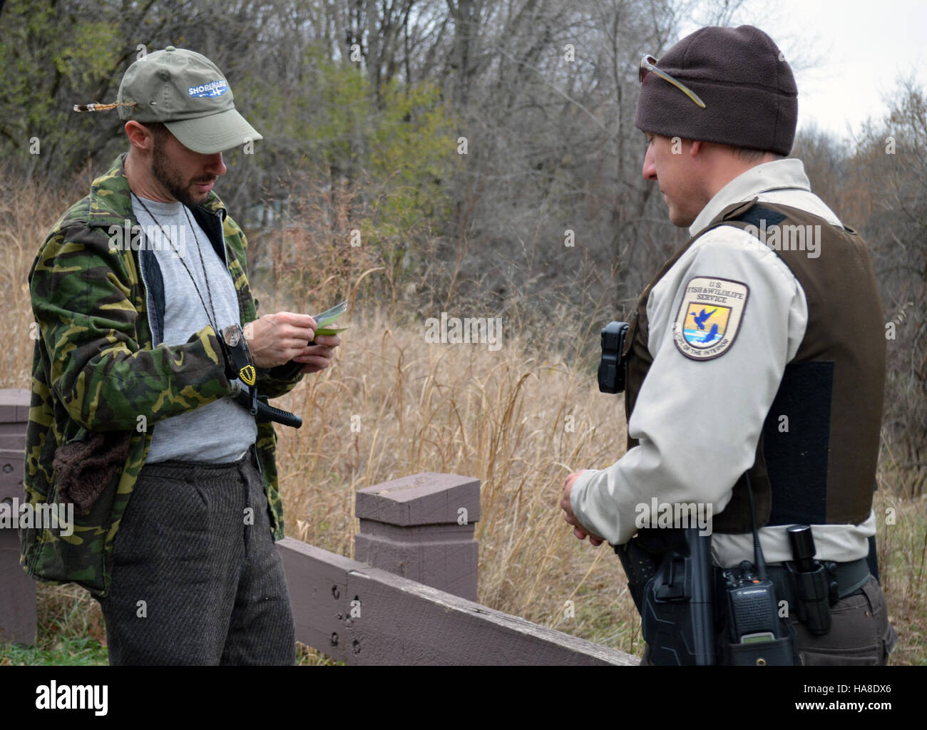 A wildlife officer checks a hunting license as part of the law ...