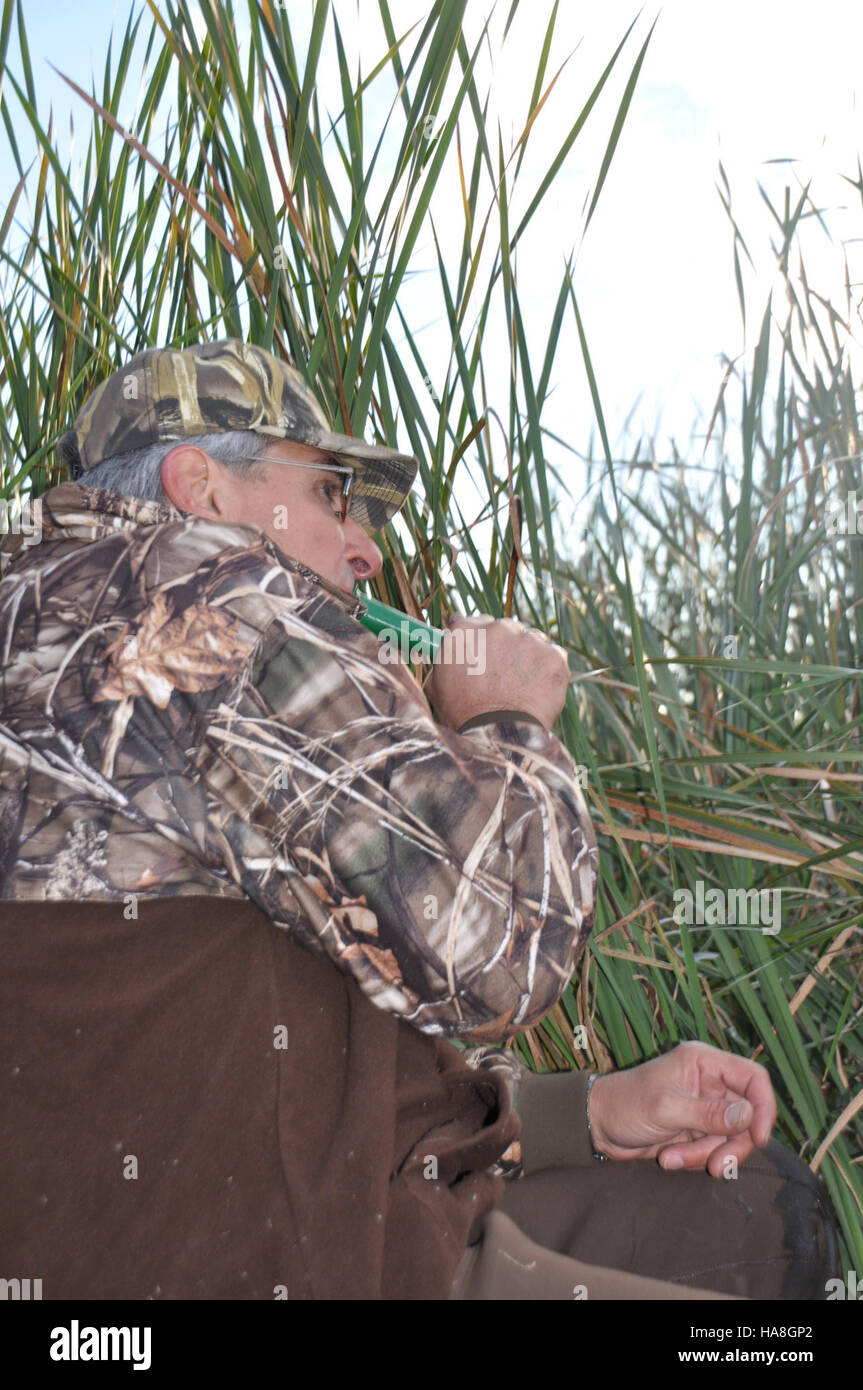 This image captures the art of duck calling, a skill used for hunting ...