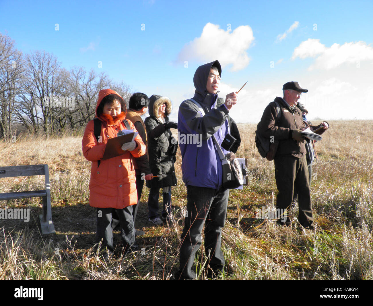 WU Lilei, a wildlife specialist, observes the surrounding environment ...