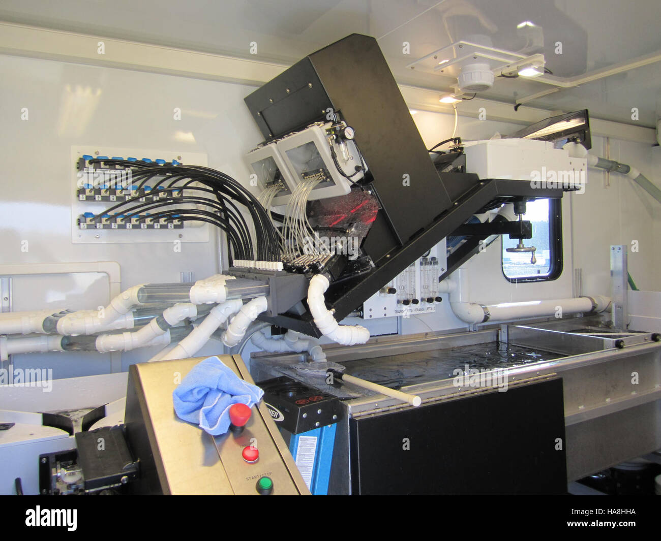 A Fish and Wildlife Service (FWS) worker operates a fish sorter, an ...
