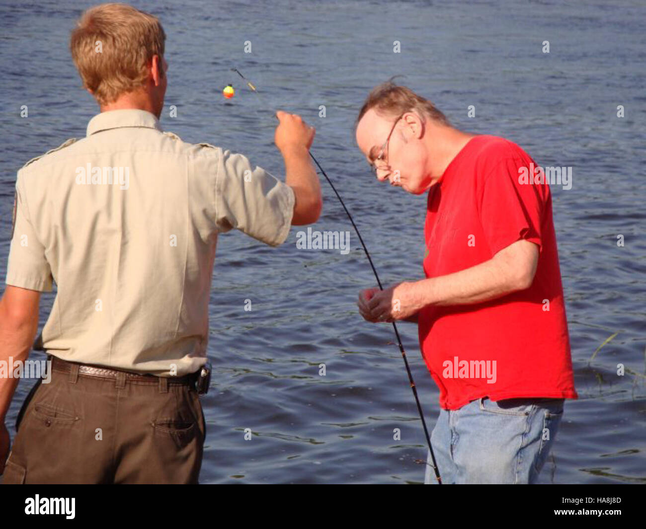 Kyle Slifka of the U.S. Fish and Wildlife Service assists with a line ...