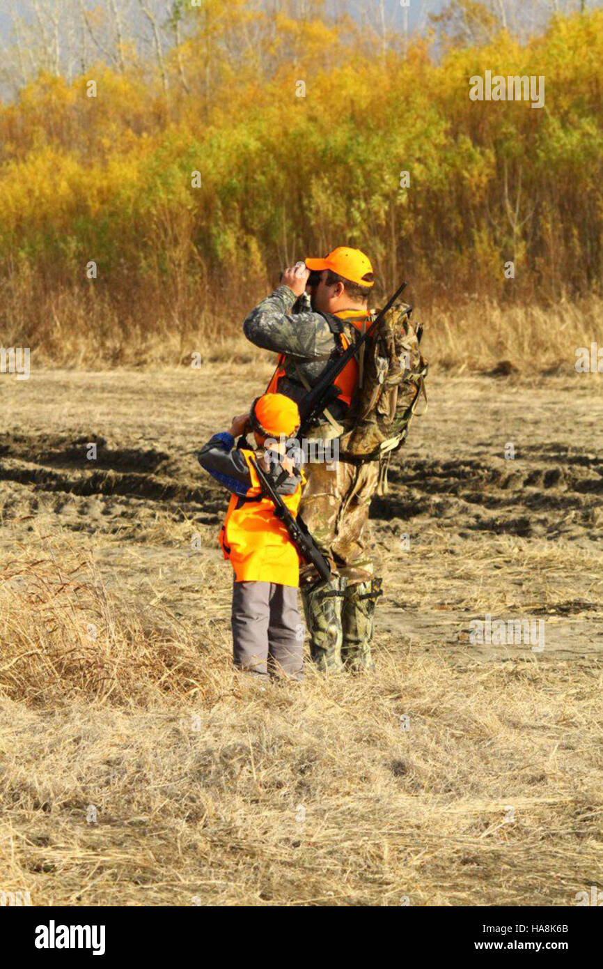 A father and son participate in a hunting activity in a Midwest ...