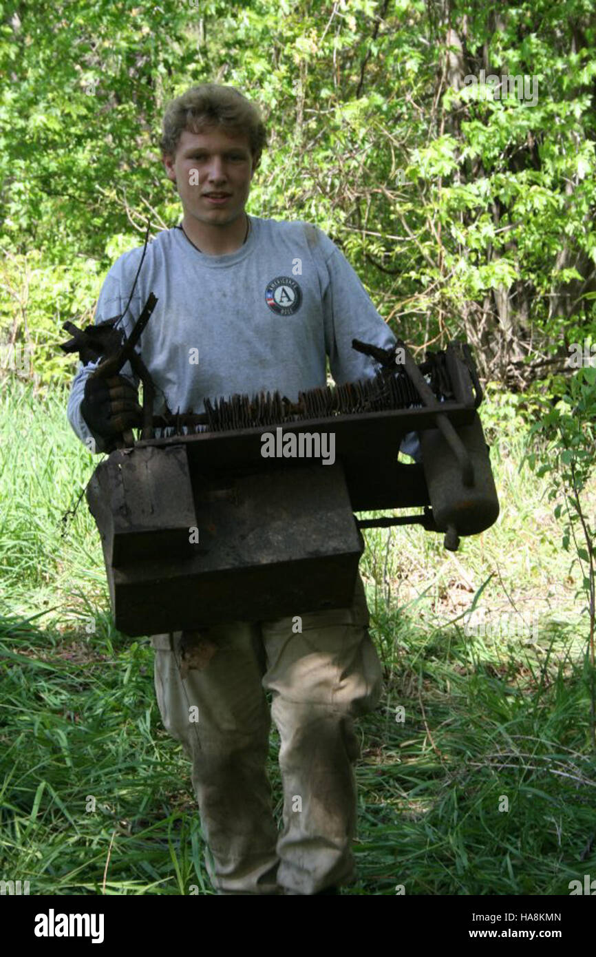 The image shows a worker handling equipment for wildlife conservation ...