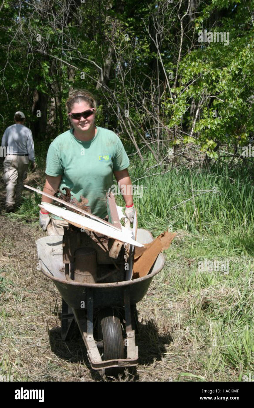 Ashley, pictured with a wheelbarrow, is involved in environmental ...