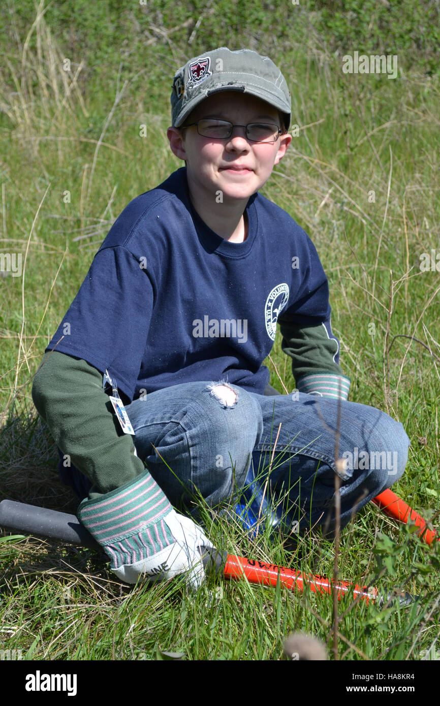 Scout John participates in a habitat restoration project by removing ...