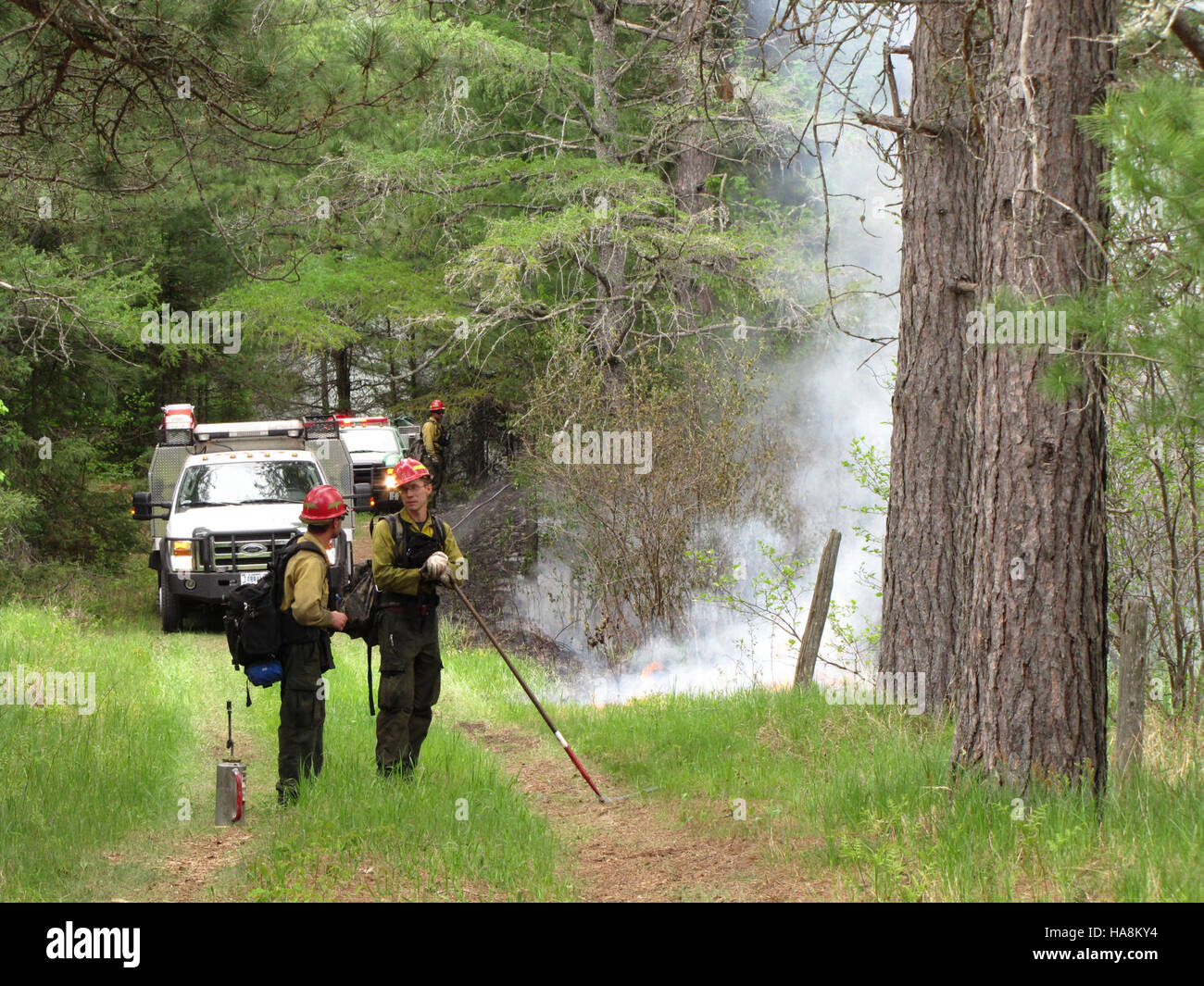 A fire crew in the Midwest prepares for a controlled backfire flare-up ...