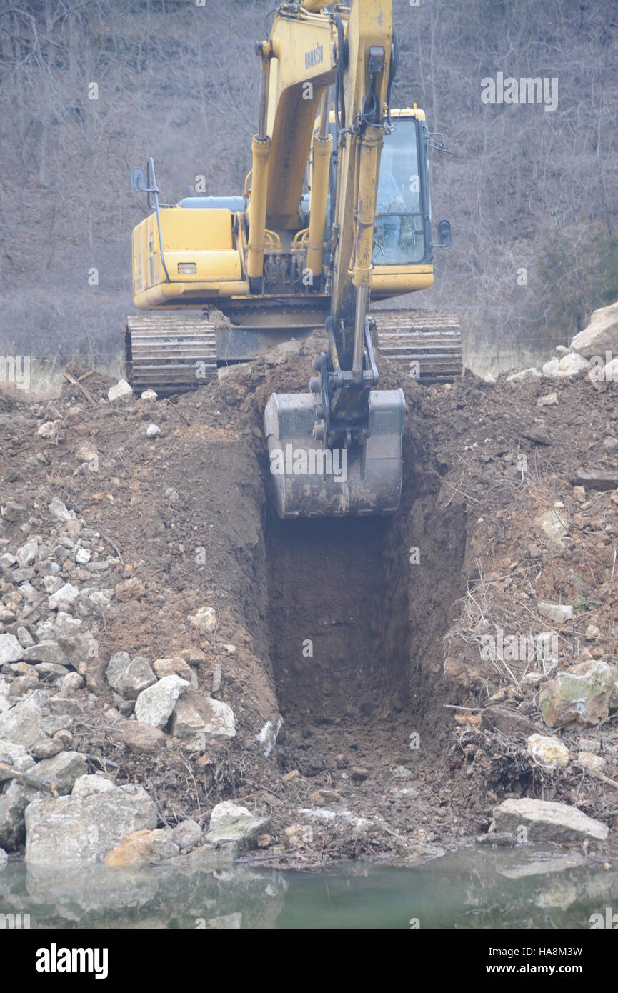 This image shows wildlife researchers conducting excavation or soil ...