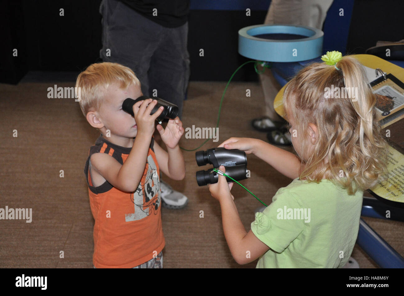 Visitors explore exhibits showcasing wildlife and ecosystems at a ...