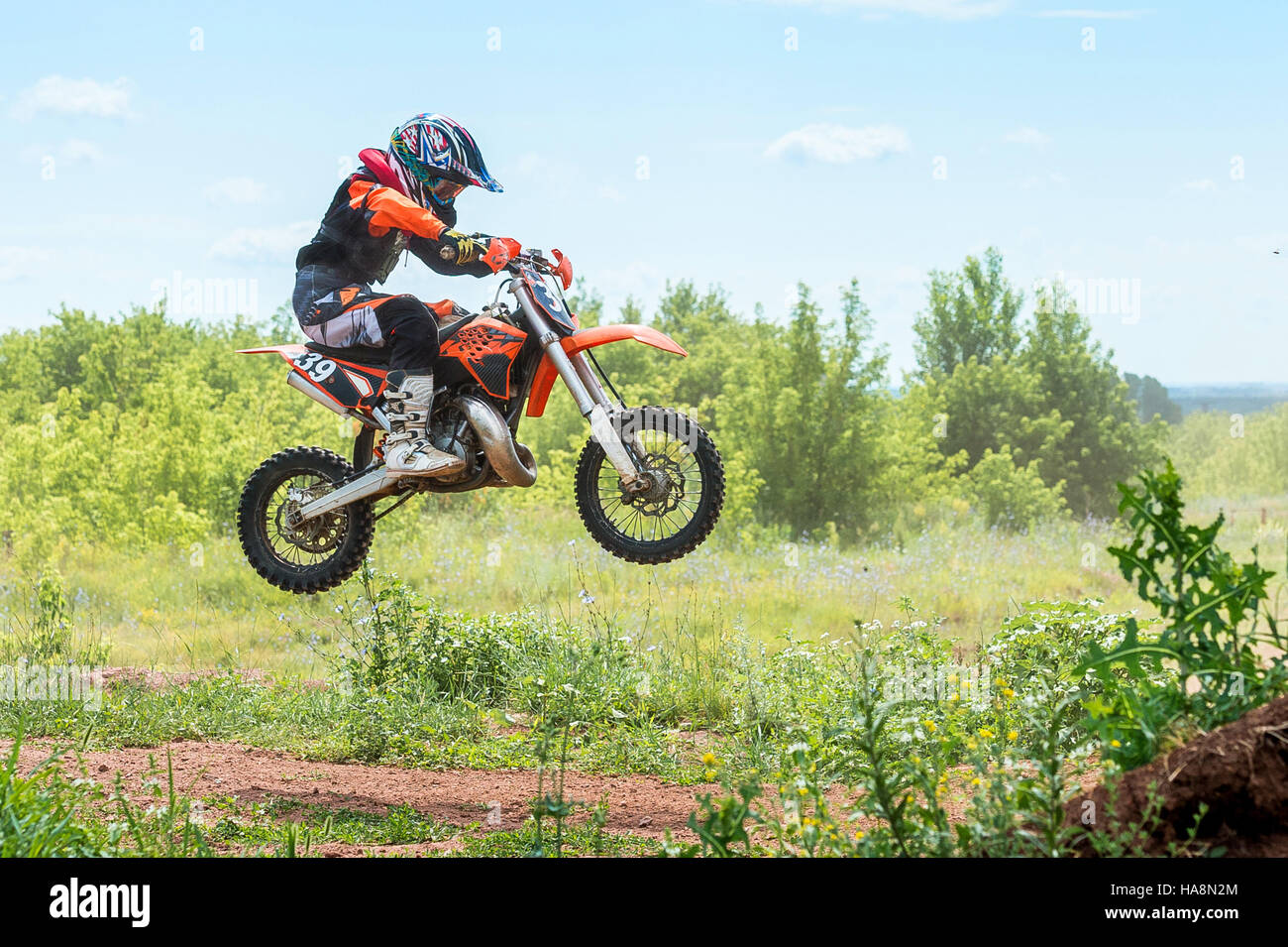 The young sportsman on a motorcycle jump Stock Photo - Alamy