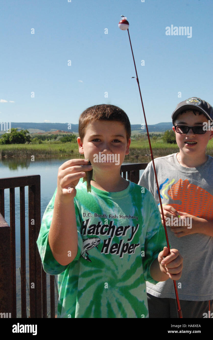 At the D.C. Booth National Fish Hatchery, a hatchery worker proudly ...