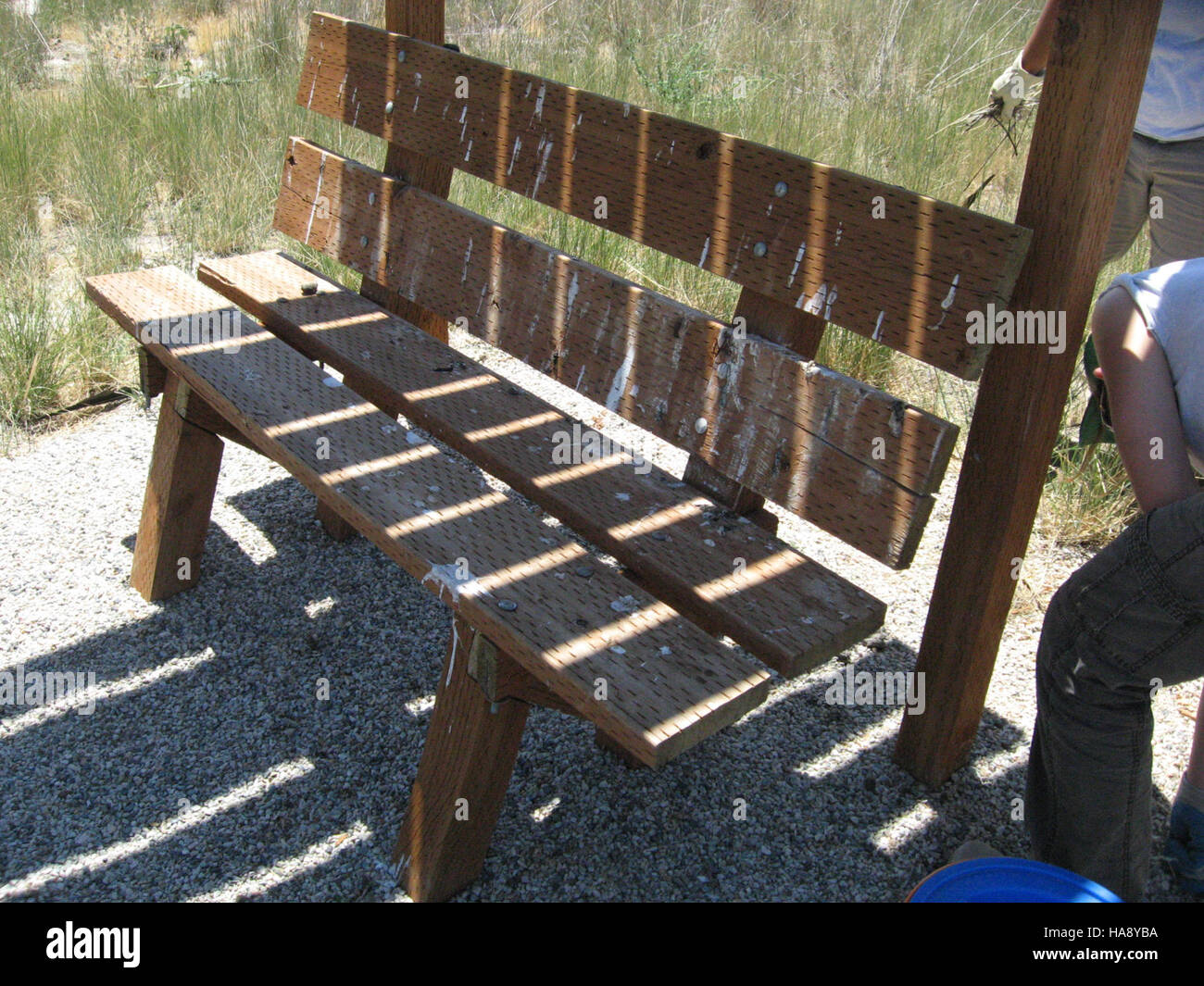 A weathered bench in a national park symbolizes the intersection of ...
