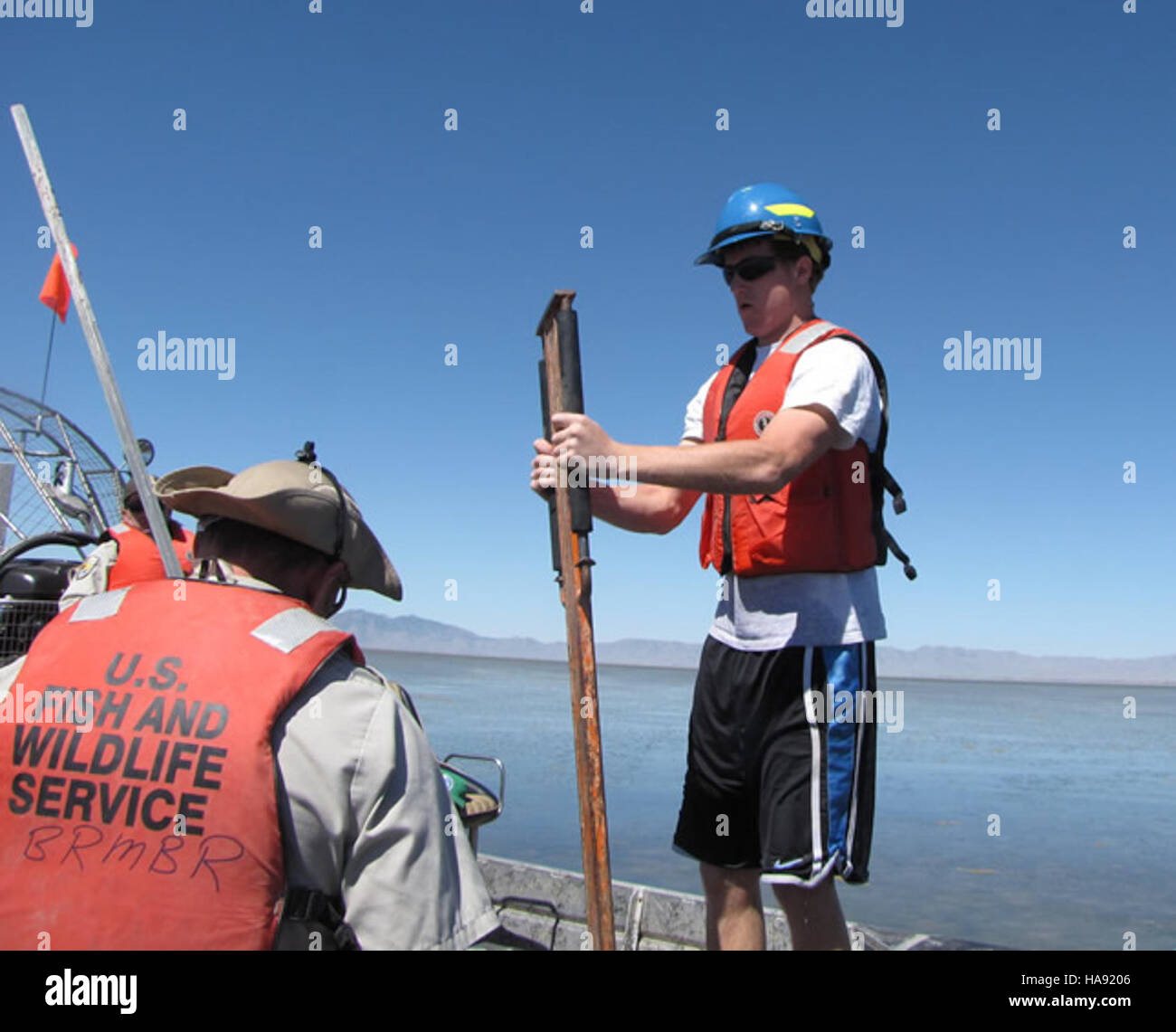 A Youth Conservation Corps participant helps install a boundary sign at ...