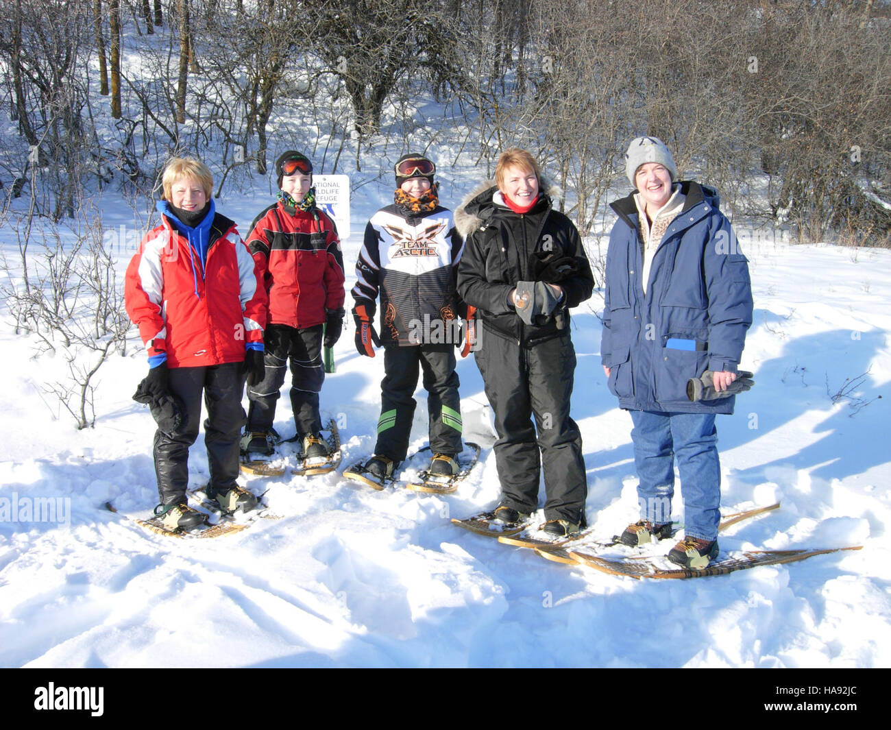 A group of outdoor enthusiasts enjoys snowshoeing in the Rocky Mountain ...