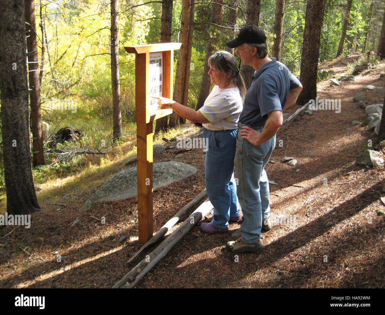 Visitors observe educational Nature Trail signs, promoting ...