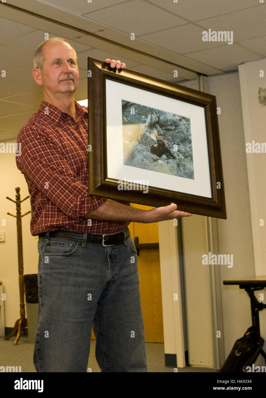 Ed Bangs, a wildlife expert, presents a framed image of his favorite ...